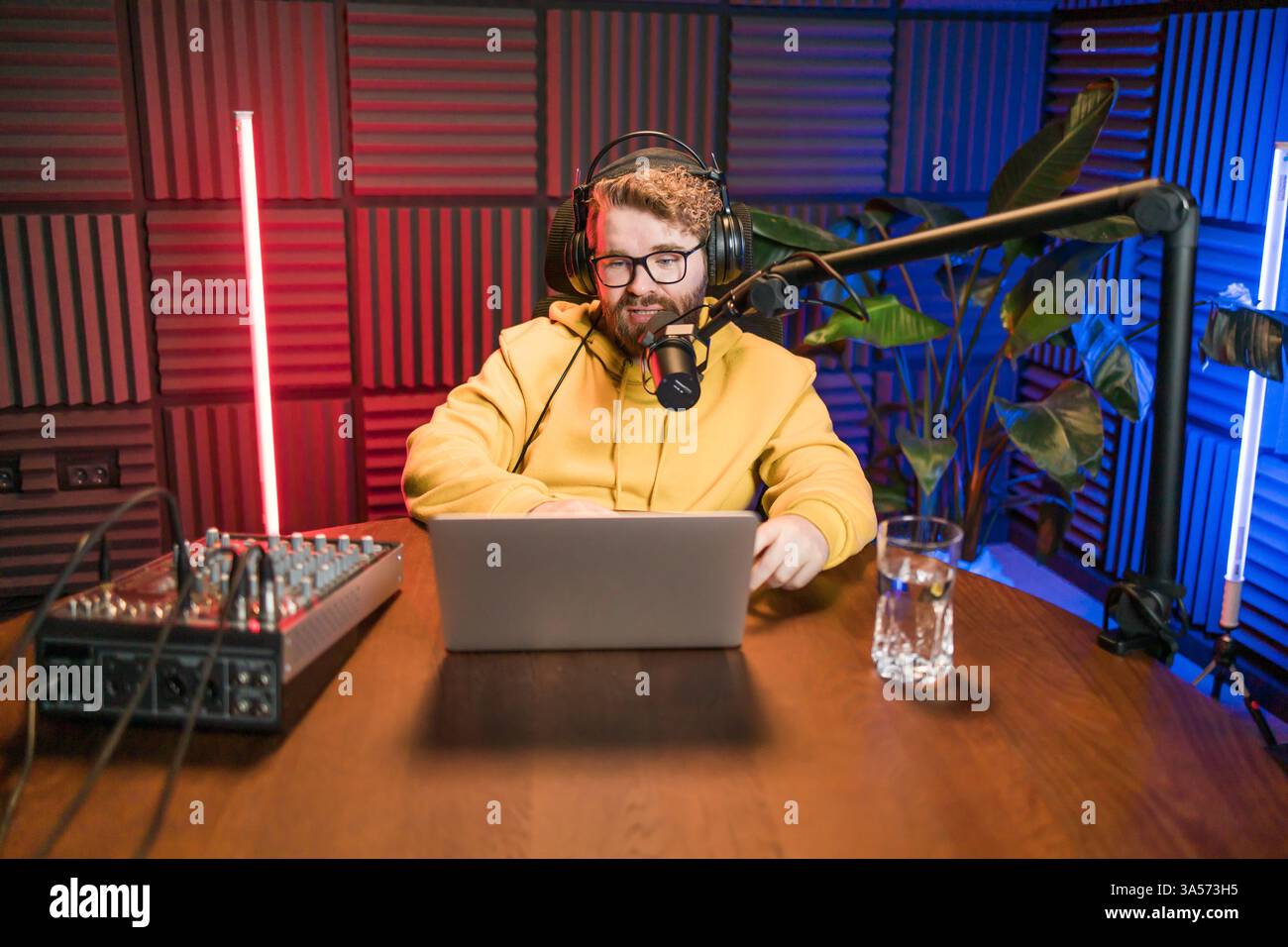 Live streaming with smiling millennial man as radio presenter with ...