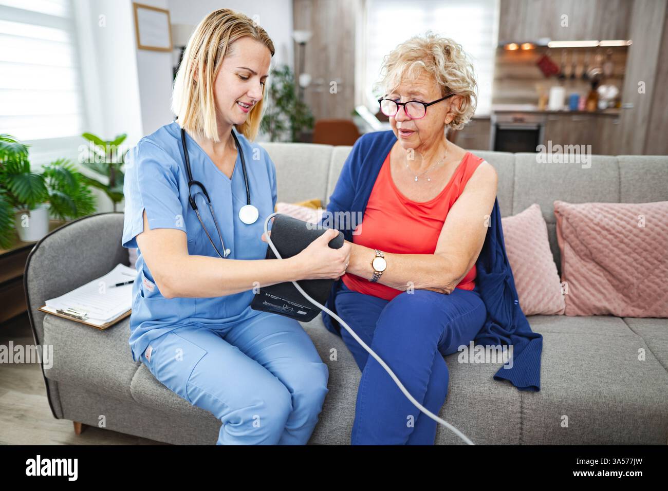 Caring nurse checks vital signs hi-res stock photography and images - Alamy