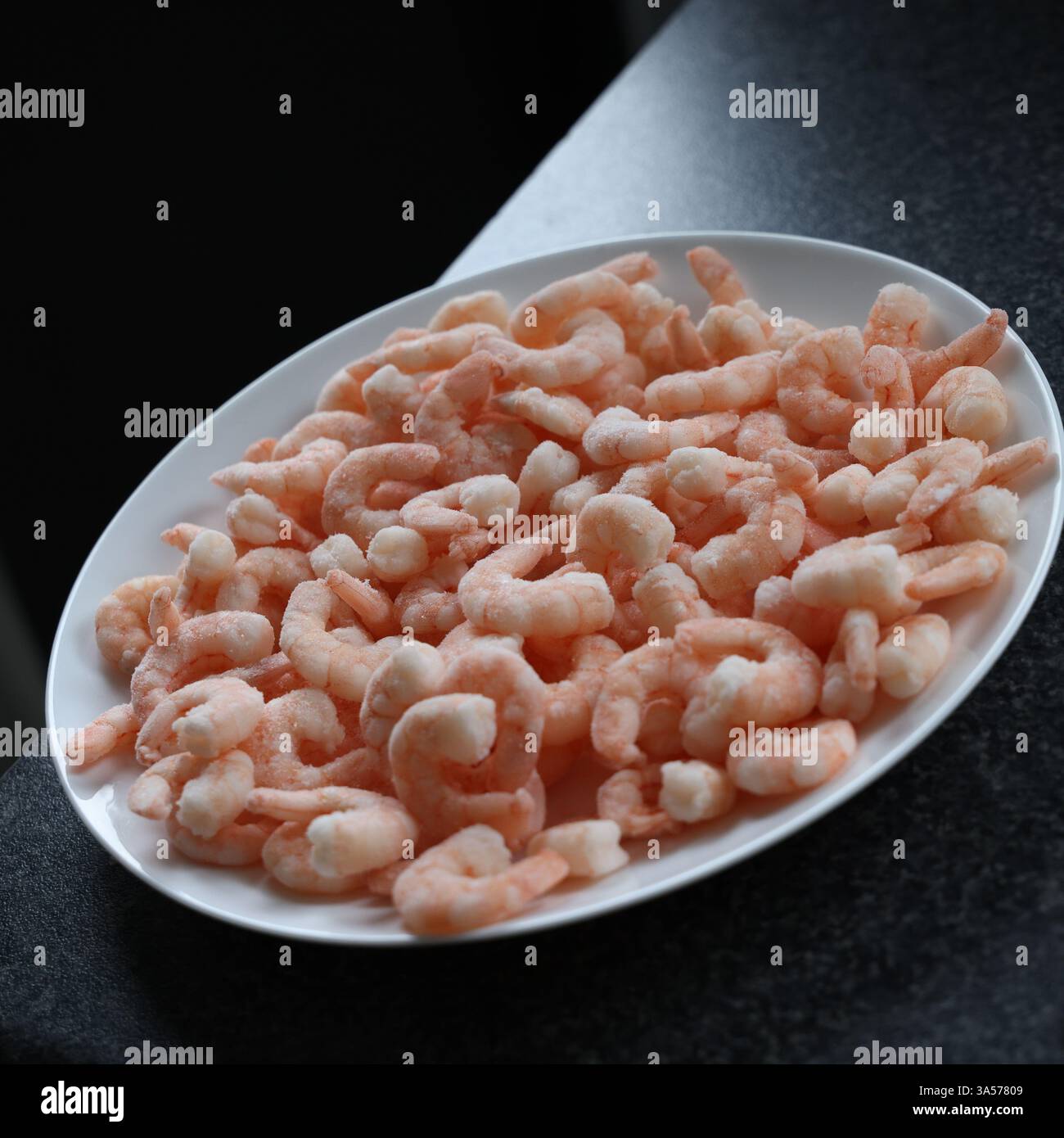 Frozen prawns in a plate Stock Photo - Alamy