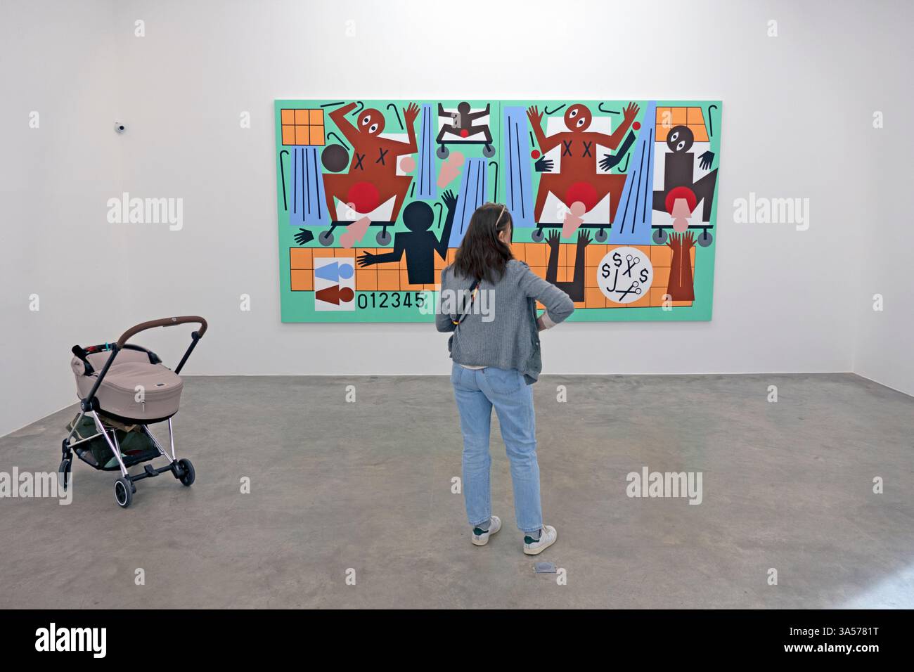 A woman seen in front of a monumental painting by artist Nina Chanel ...