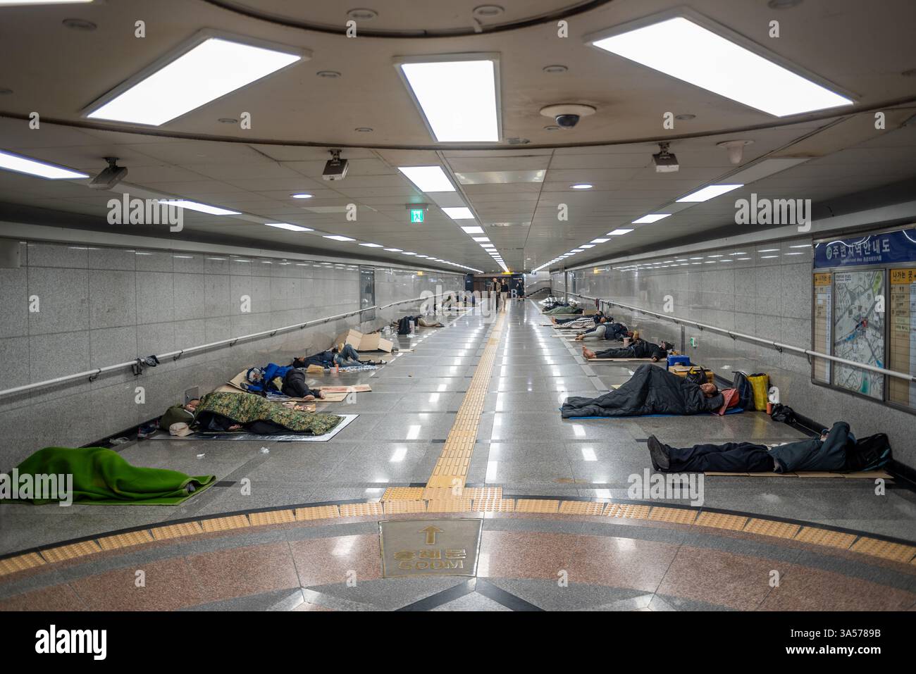 Homeless people sleeping in the hallways leading to subway station of ...