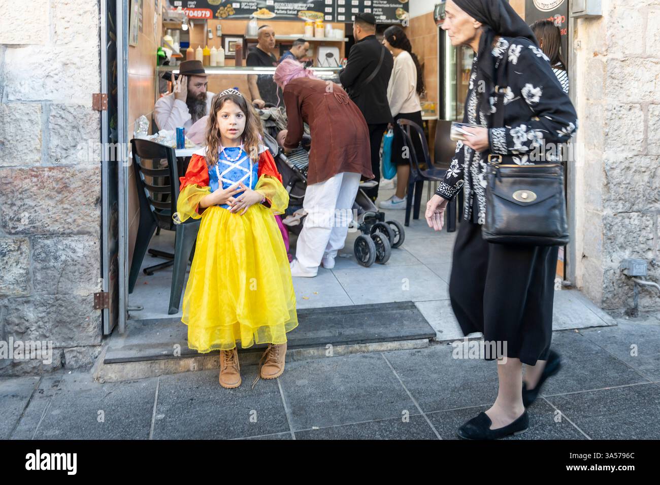 Jerusalem, Israel – March 16, 2025. A girl dressed as a princess in a ...