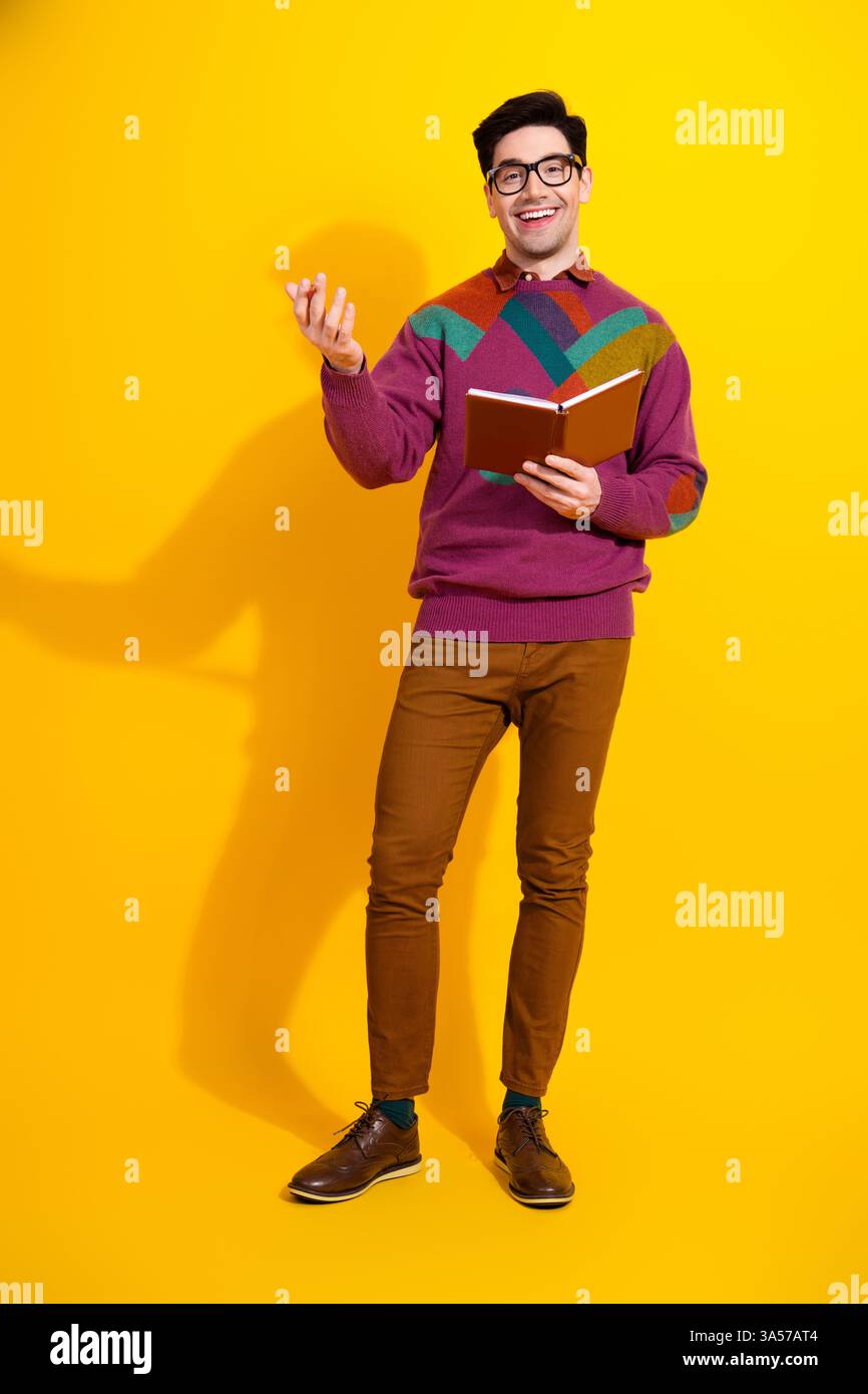 Young man in colorful sweater displaying expressive gesture while ...