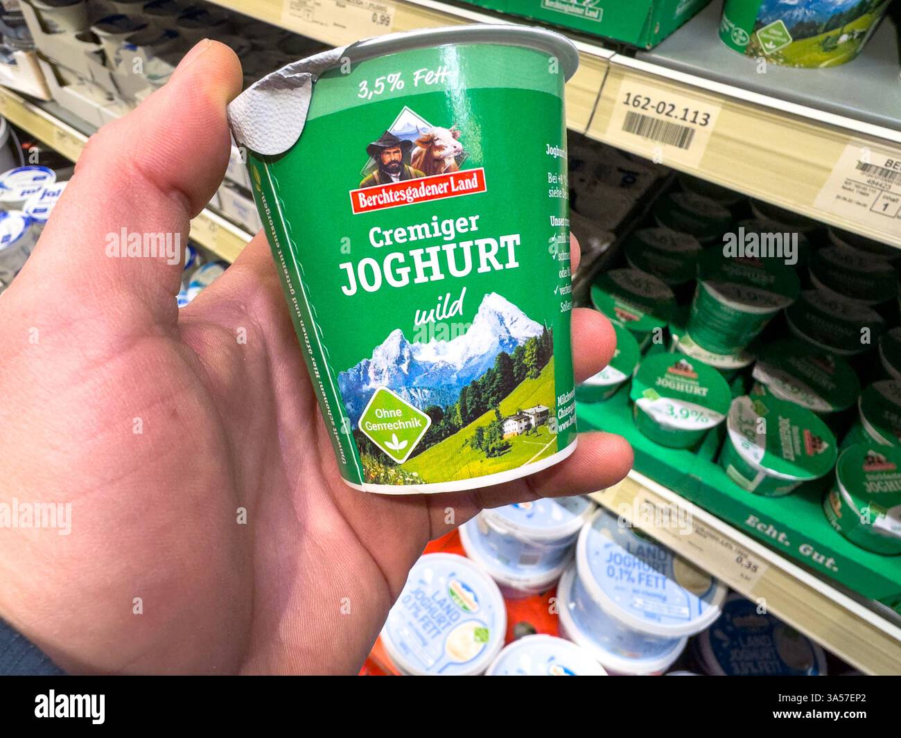 Bavaria, Germany - January 13, 2024: A hand holds a creamy yogurt from ...