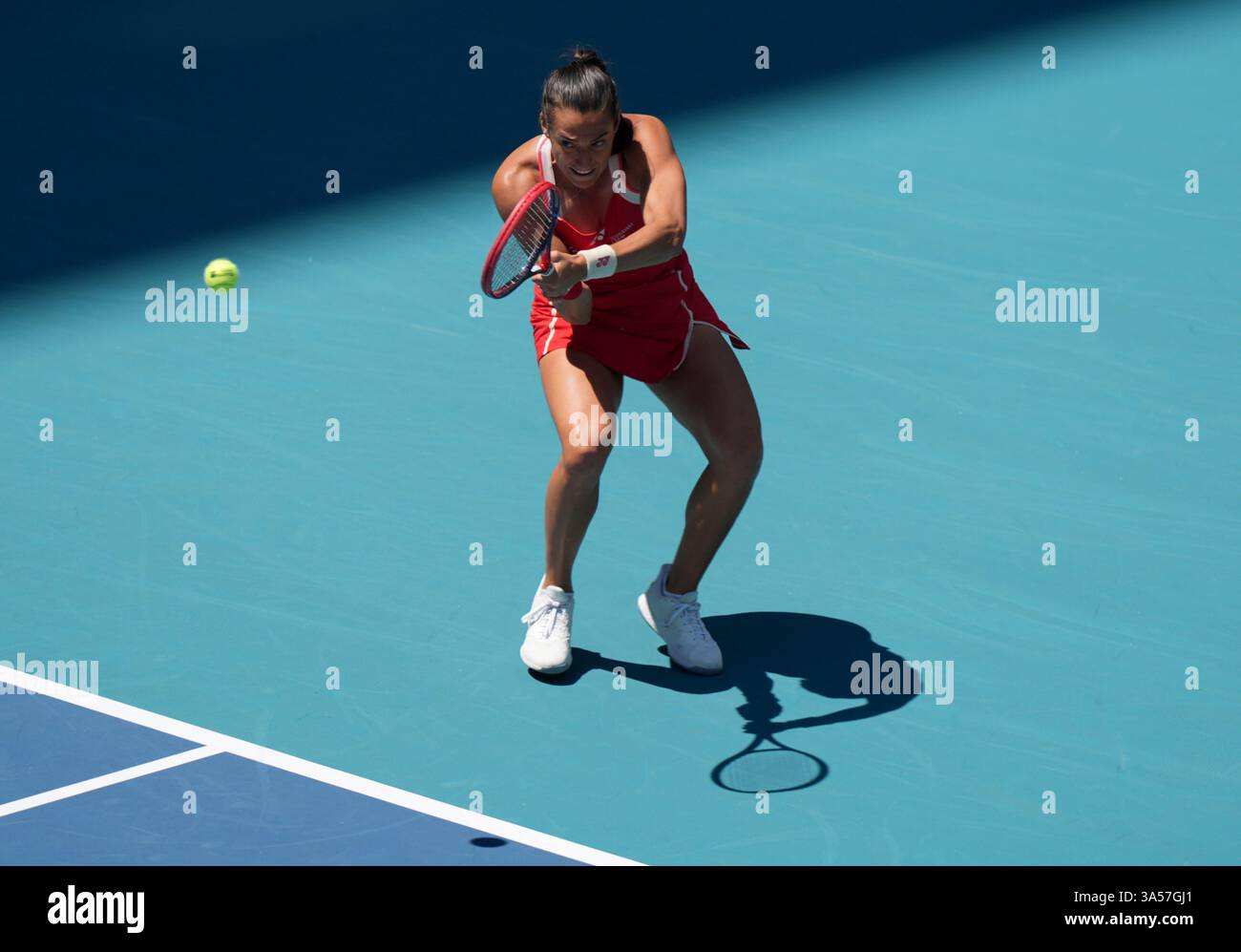 Caroline Garcia, of France, hits a return to Iga Swiatek, of Poland ...