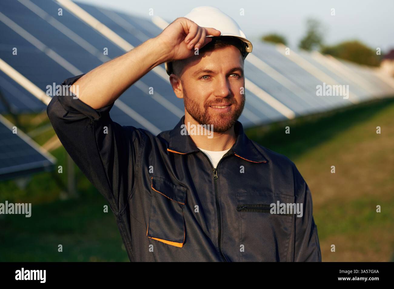 Handsome guy portrait. Man is working with solar panels outdoors at ...