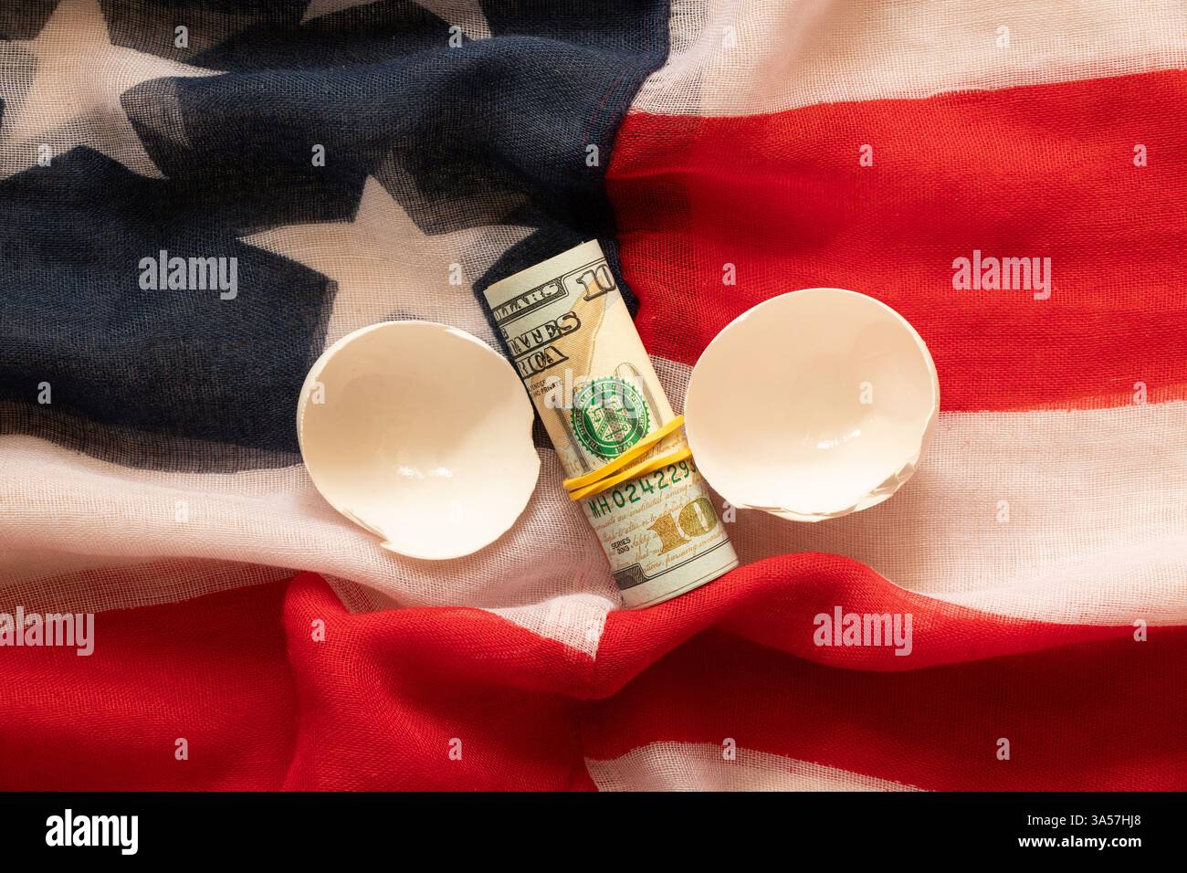 A broken chicken egg shell and a hundred dollar bill rolled up into a ...