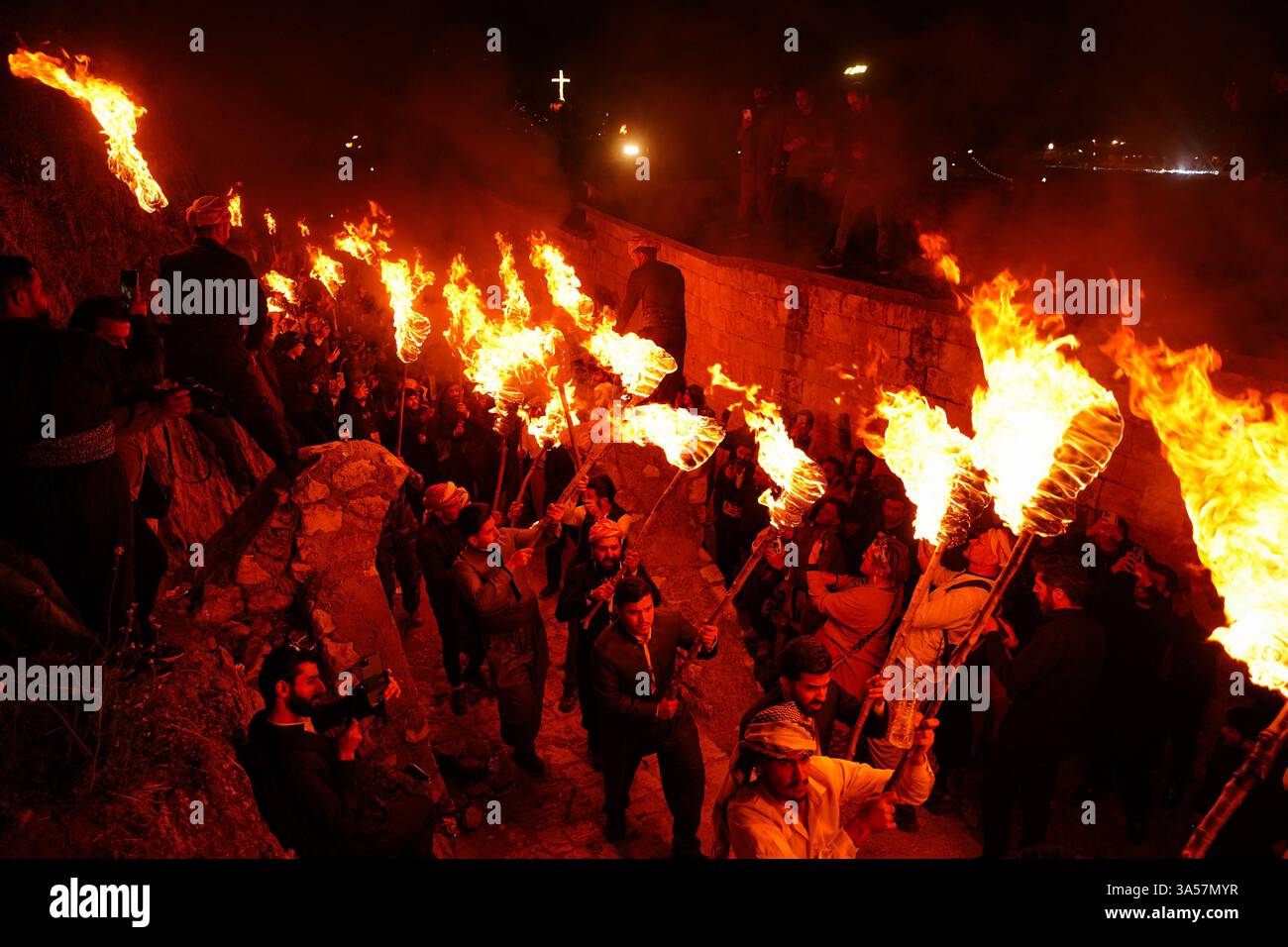 Iraqi Kurds carry fire torches as they celebrate Nowruz Day, a festival ...