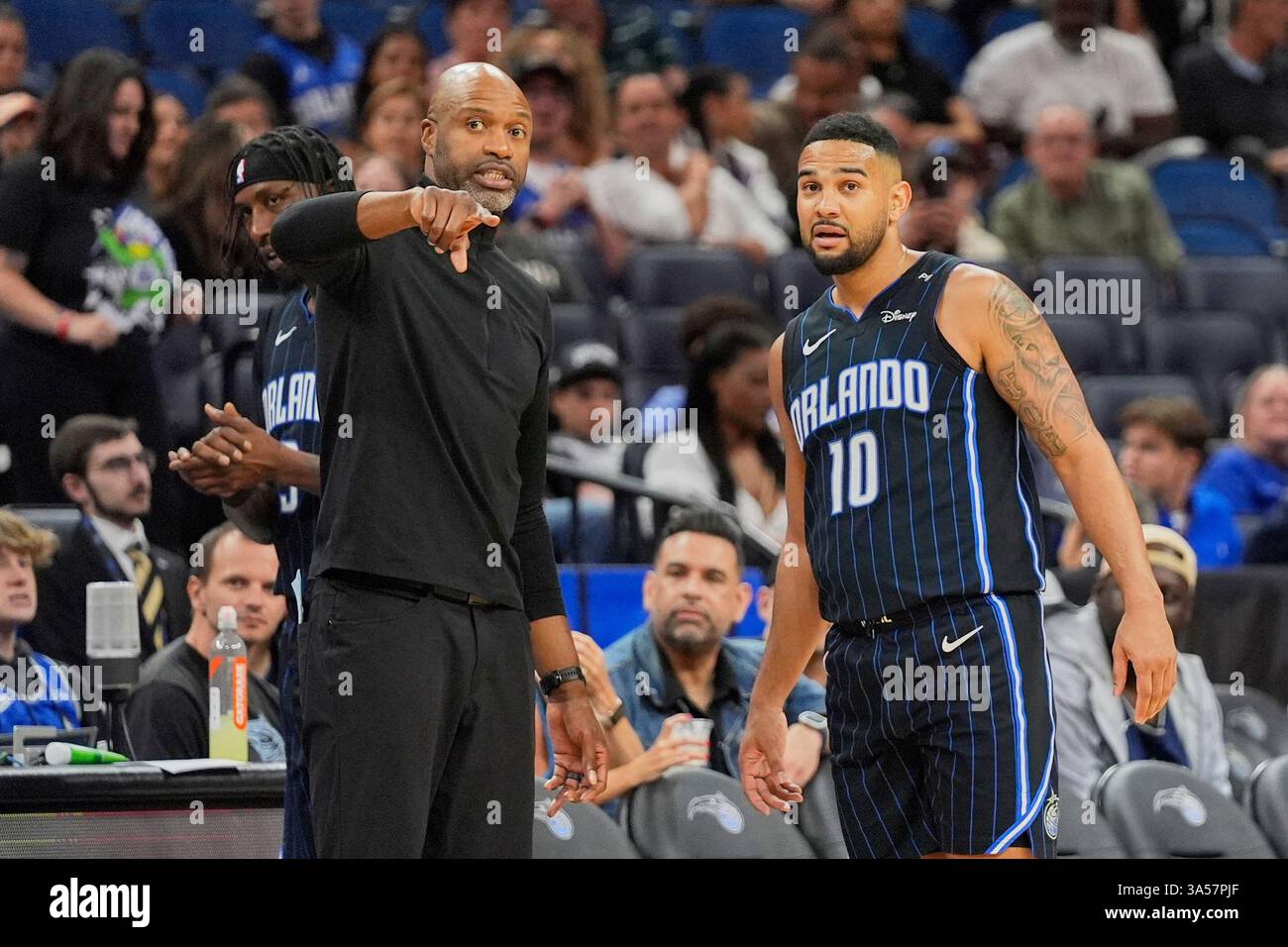 Orlando Magic head coach Jamahl Mosley, left, talks with guard Cory ...