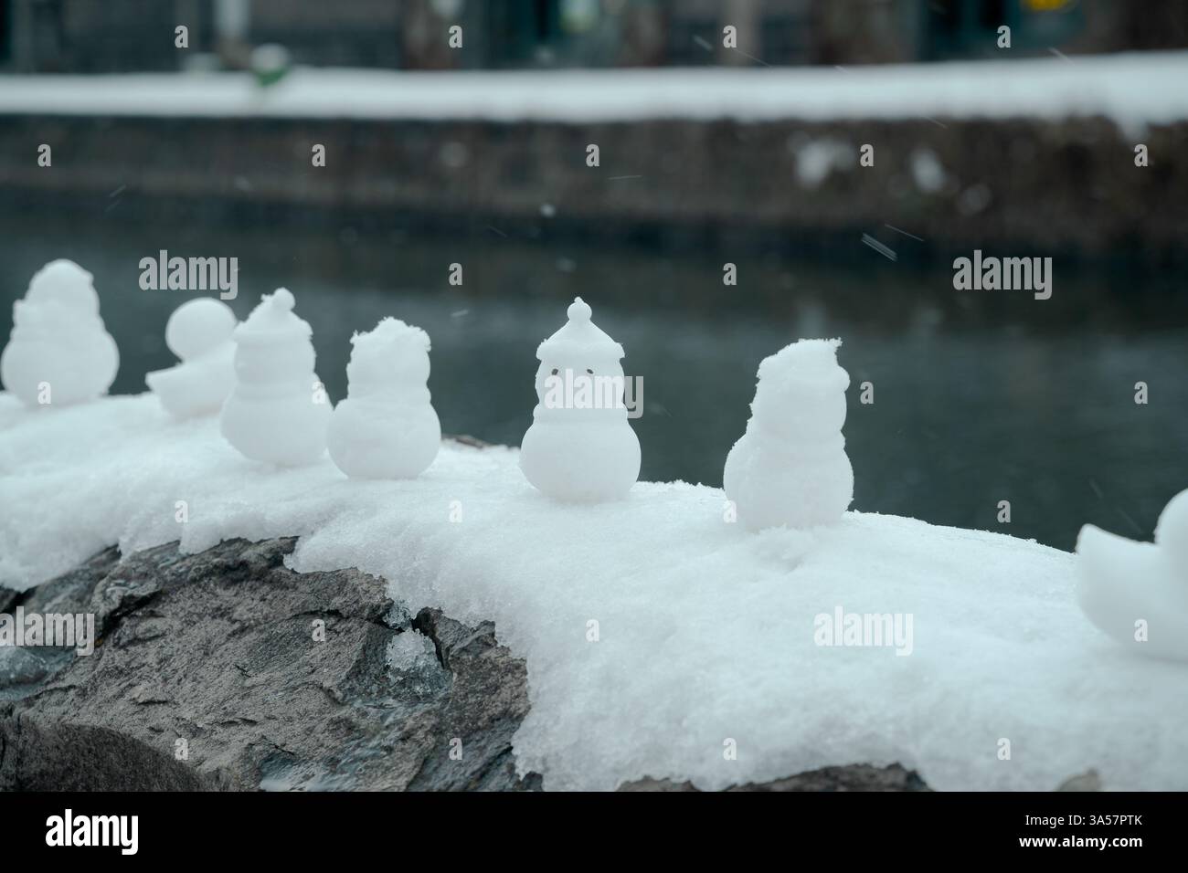 Cute small snow dolls at the riverbank of Otaru Canal. Perfect as ...