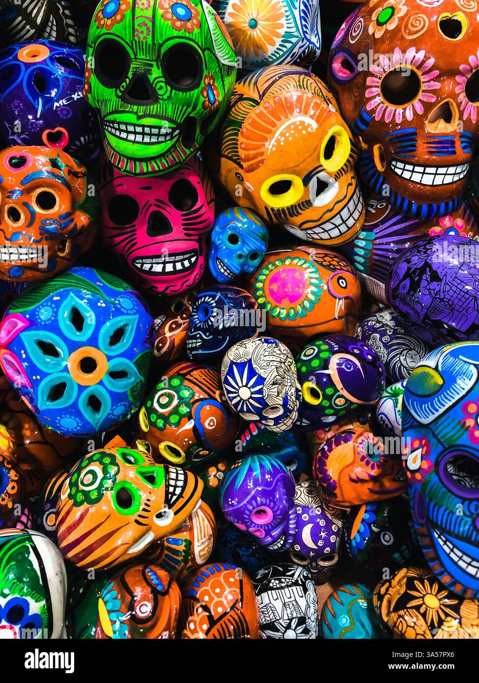 Intricately painted Dia de los Muertos skulls burst with vibrant colors ...