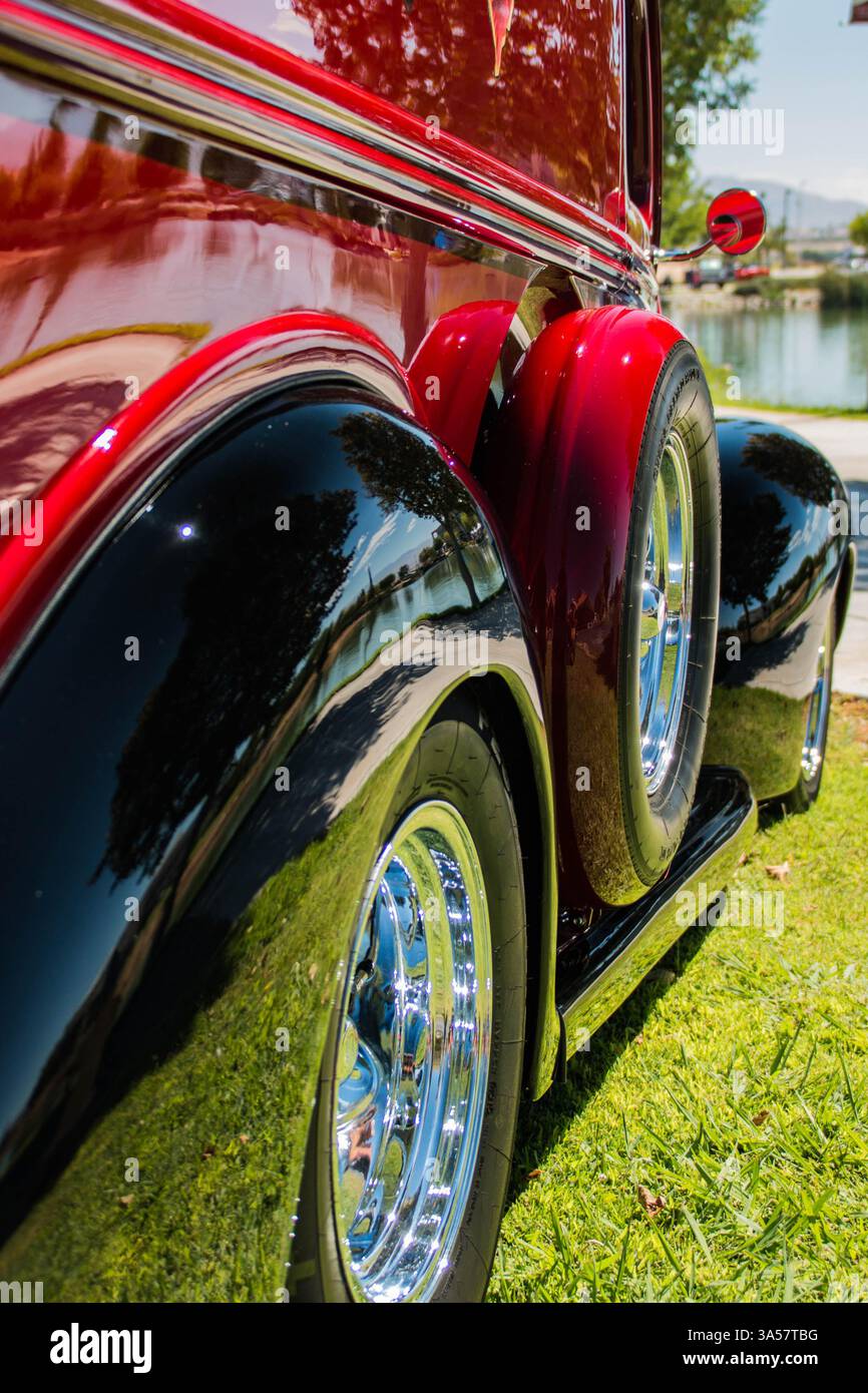The spare tire and fenders on the side of a classic panel truck at a ...