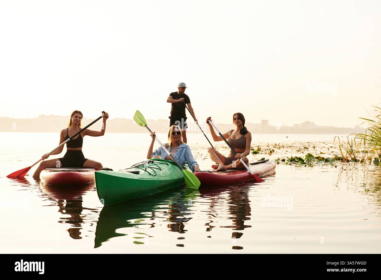 Women and man. Friends are together on sup boards on the lake Stock ...