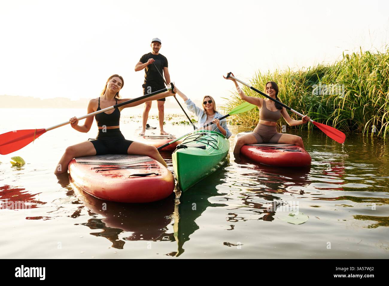 Women and man. Friends are together on sup boards on the lake Stock ...