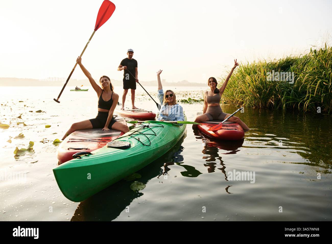 On the lake. Friends are together on sup boards Stock Photo - Alamy