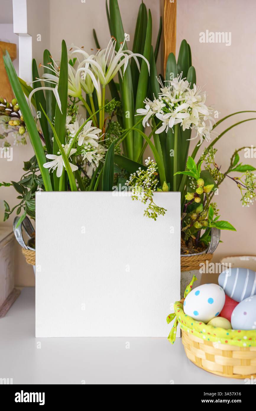 Decorative pot filled with lush green plants, white flowers and ...