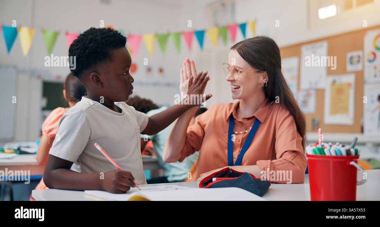 Education, teacher and high five boy in classroom for lesson support ...
