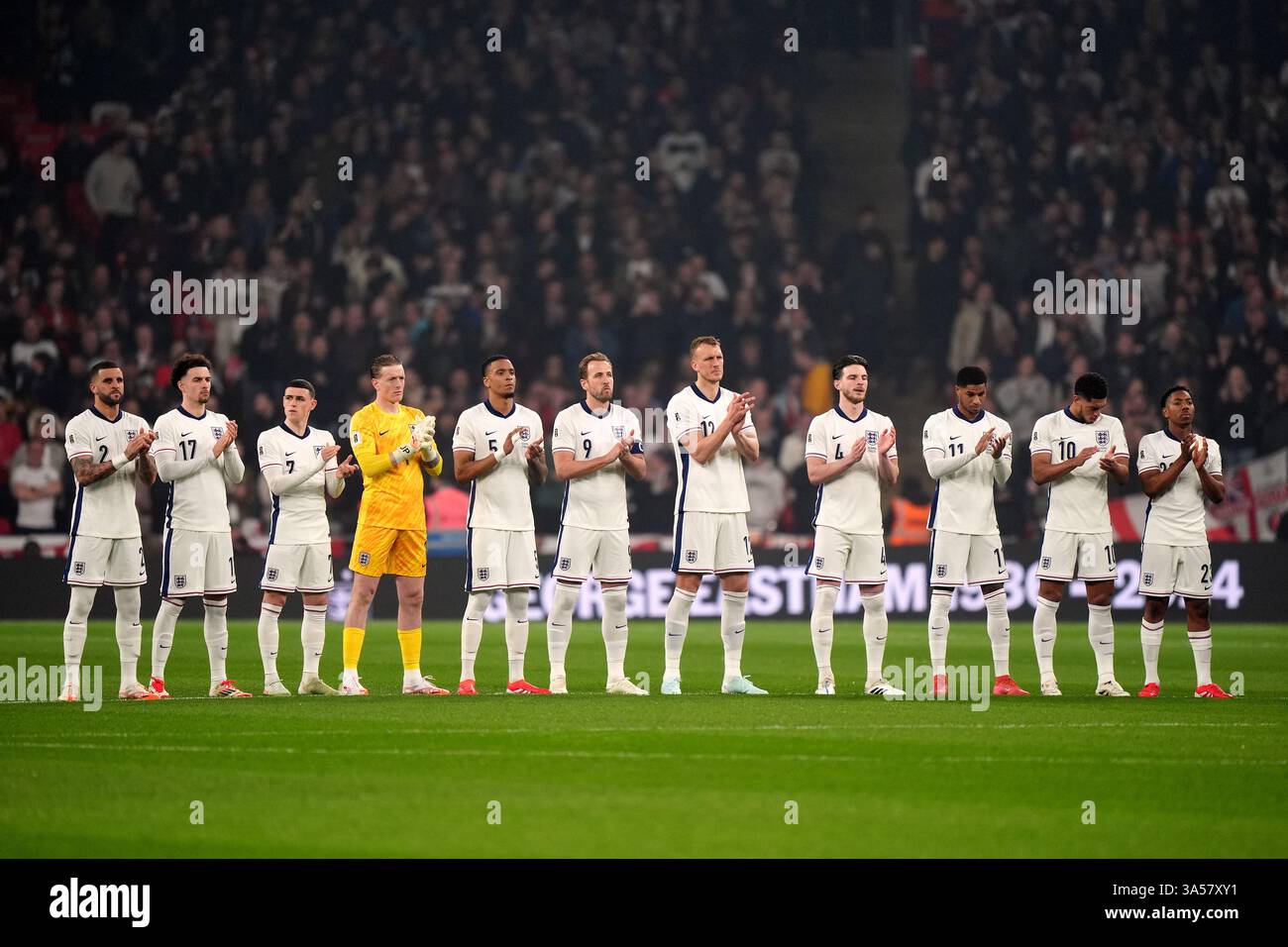 England players join a minutes applause for George Eastham during the ...
