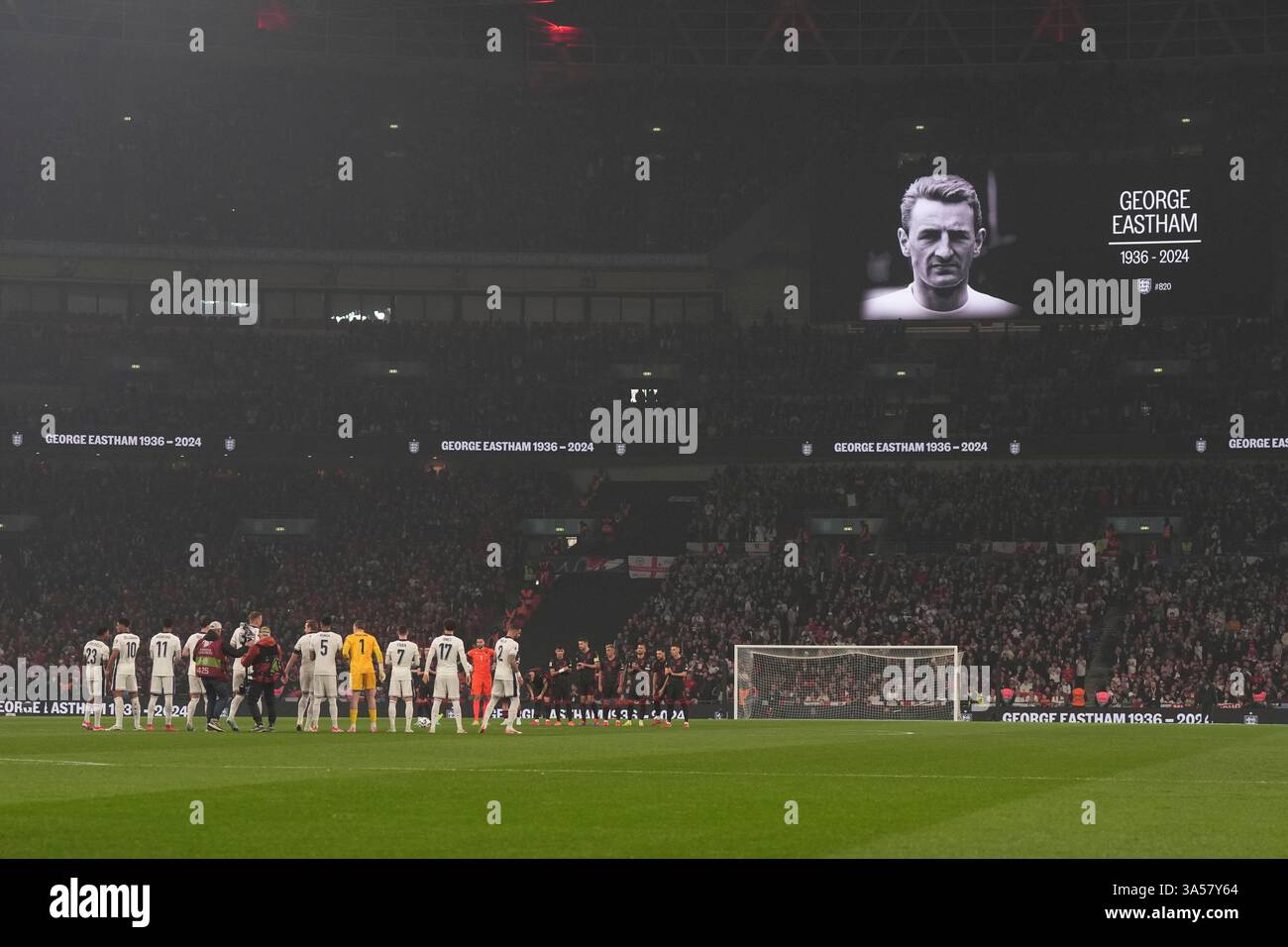 Players stand for a minute of silence of late George Eastham prior to ...