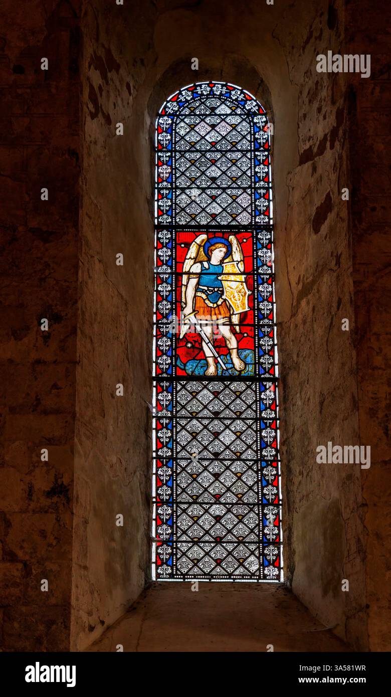 Presbytery with stained glass window depicting St Michael the archangel ...