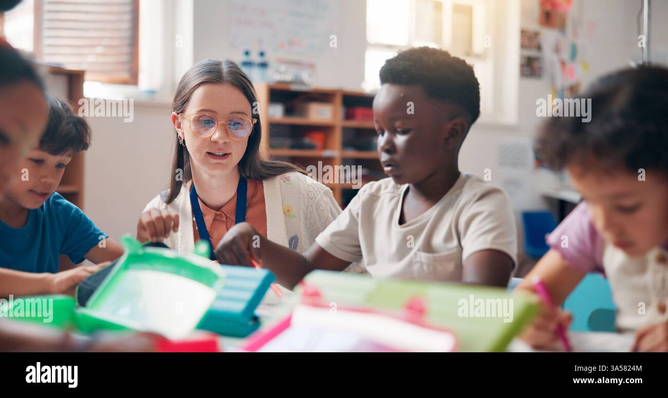 Writing, education and educator helping children in classroom for ...