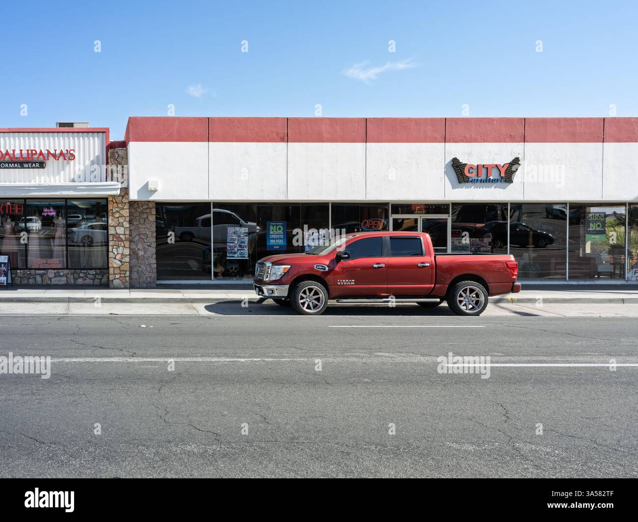 Red Nissan Texas Titan pickup truck in front of store Stock Photo - Alamy
