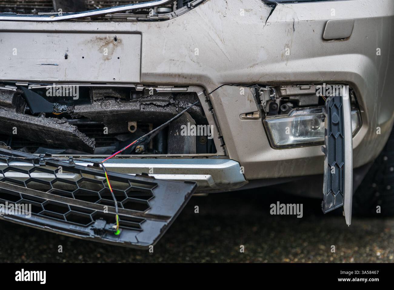 damaged silver car in parking lot with front-end collision Stock Photo ...