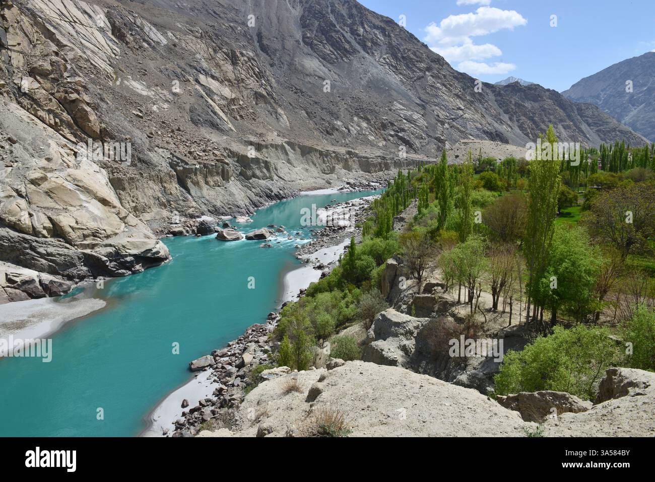 An aerial panorama of a valley and a flowing river of green glacial ...