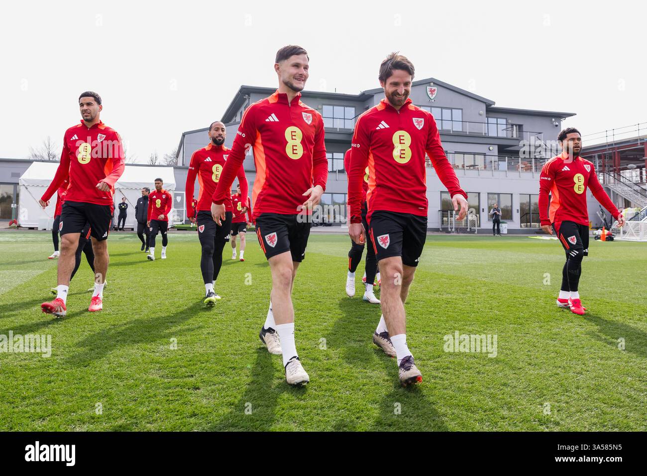 PONTYCLUN, WALES - 21 MARCH 2025: Wales' Liam Cullen, Wales' Joe Allen ...