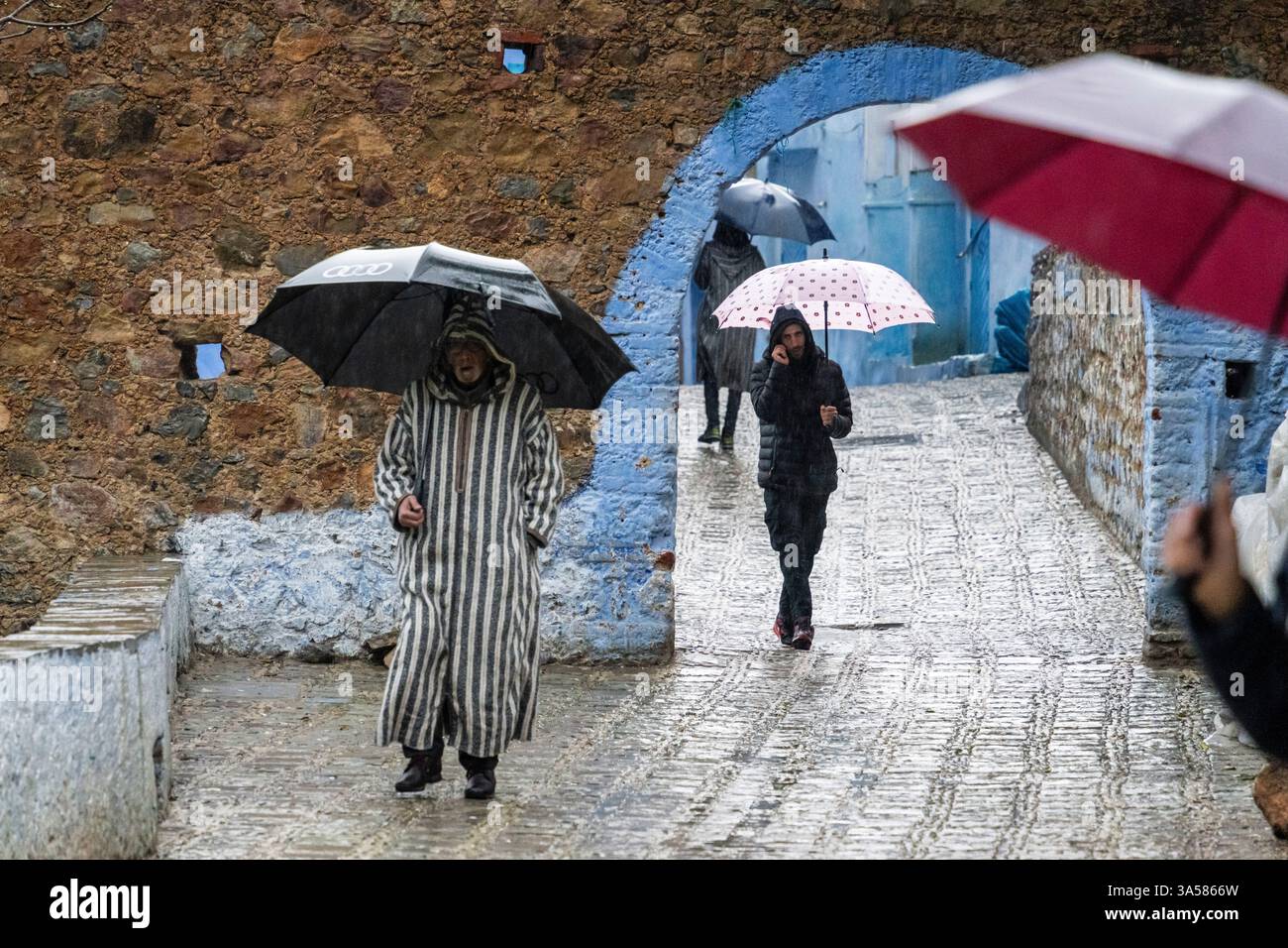People with umbrellas in Bab El Onsar, 16th century gate, Ras el Maa ...