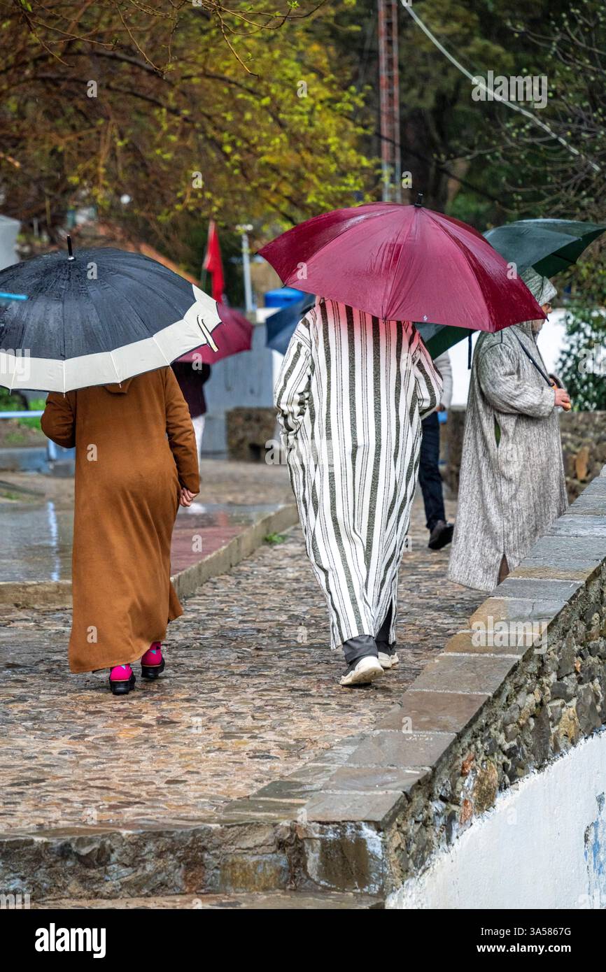 People with umbrellas in the rain, Ras el Maa, Chefchaouen, Rif ...