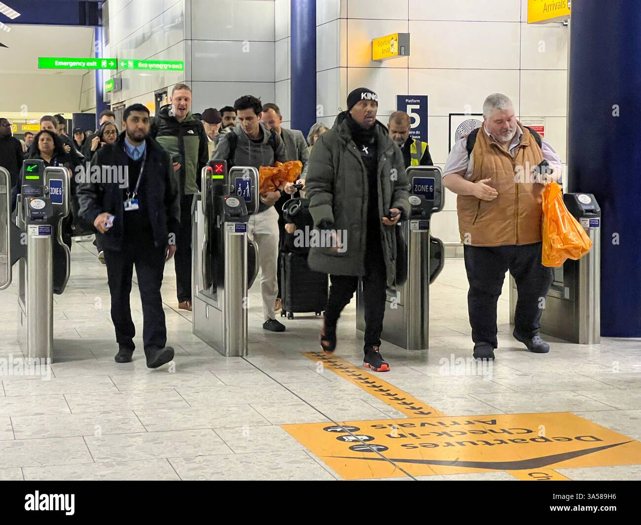 Passengers at Heathrow Terminal 5 station in London. British Airways ...