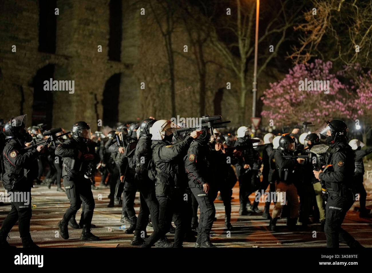 Police officers use anti riot rifles to disperse people during a ...