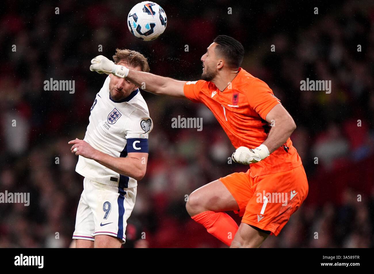 England's Harry Kane heads the ball as Albania Goalkeeper Thomas ...