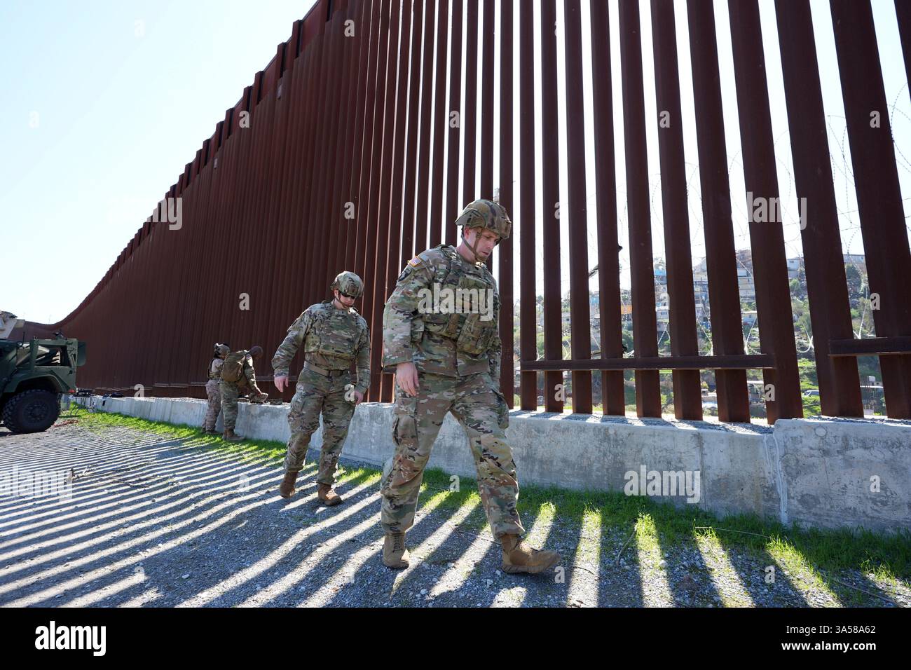 Lt. Col. Phillip Mason, right, walks during a news conference on joint ...