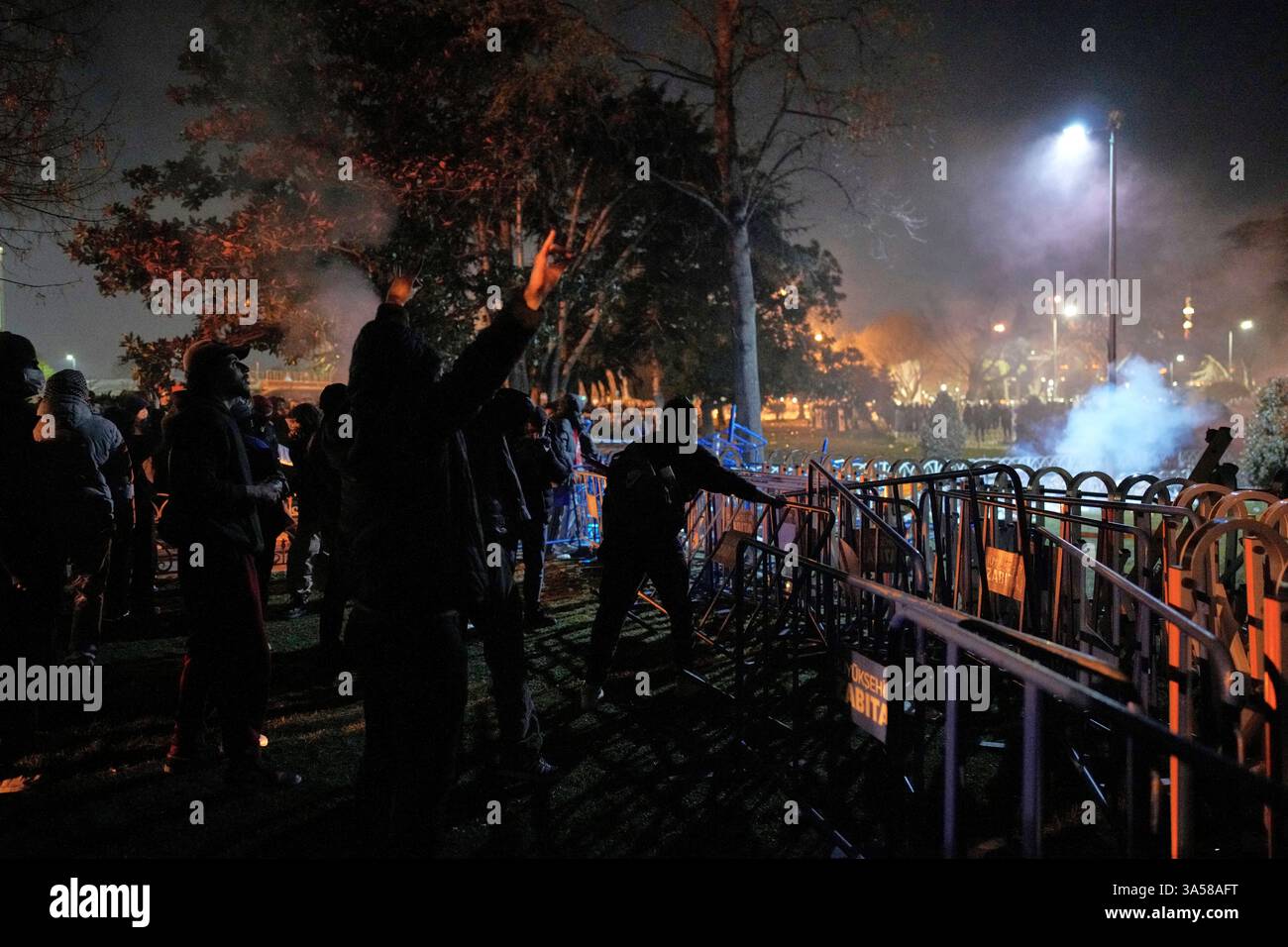Protesters shout slogans during clashes with anti riot police during a ...