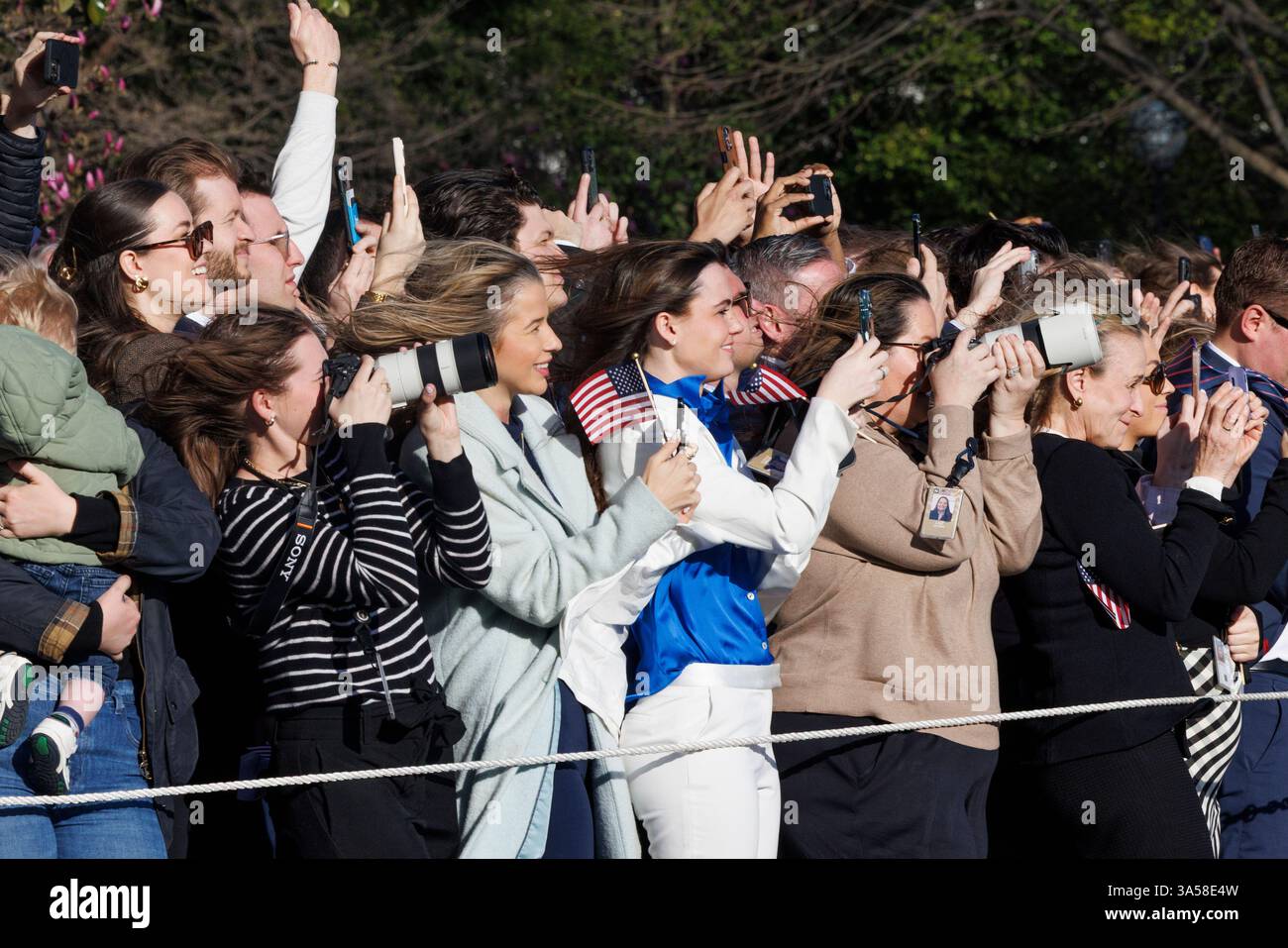 Visitors face a gust from Marine One, carrying President Donald Trump ...