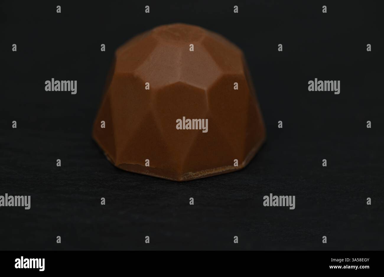 A beautifully crafted chocolate treat showcases an intricate geometric ...