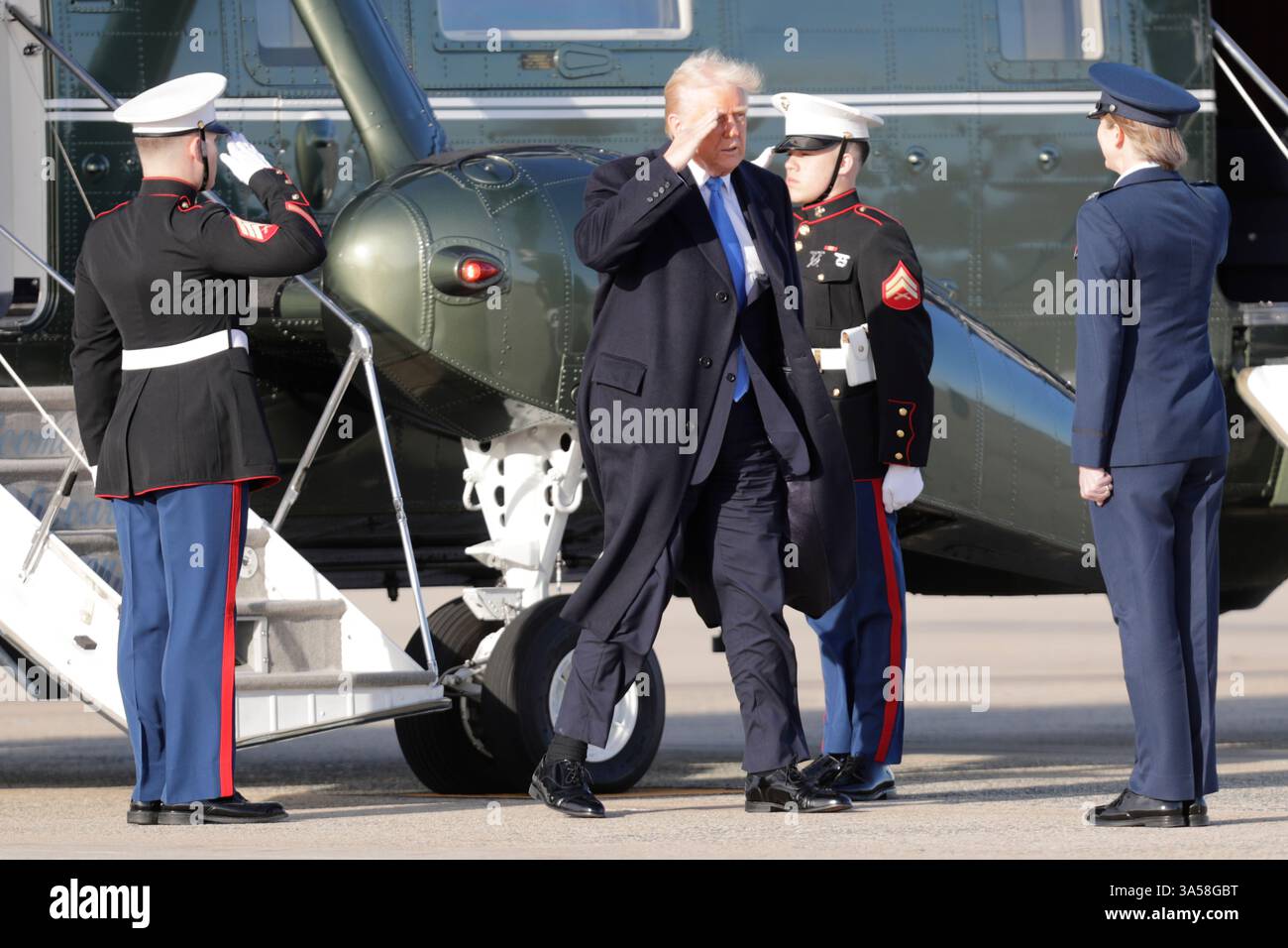 President Donald Trump, center, is greeted by Air Force Col. Angela F ...