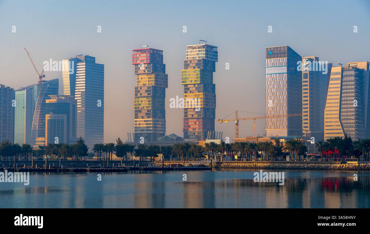 Doha, Qatar -February 24, 2025: A foggy morning in Doha with skyscrapers partially hidden in ...