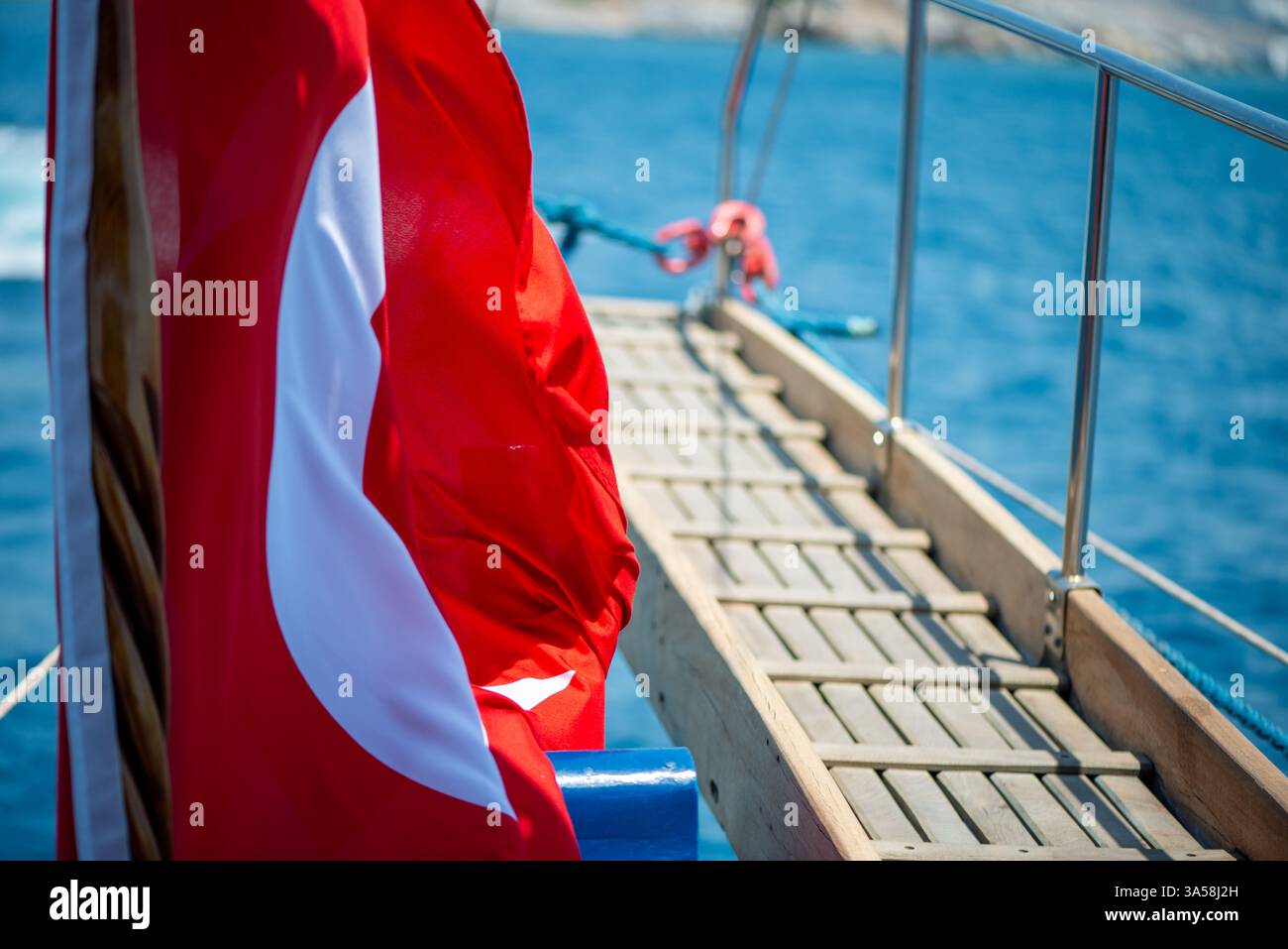 A vibrant Turkish flag proudly waving on a touristic yacht, symbolizing ...