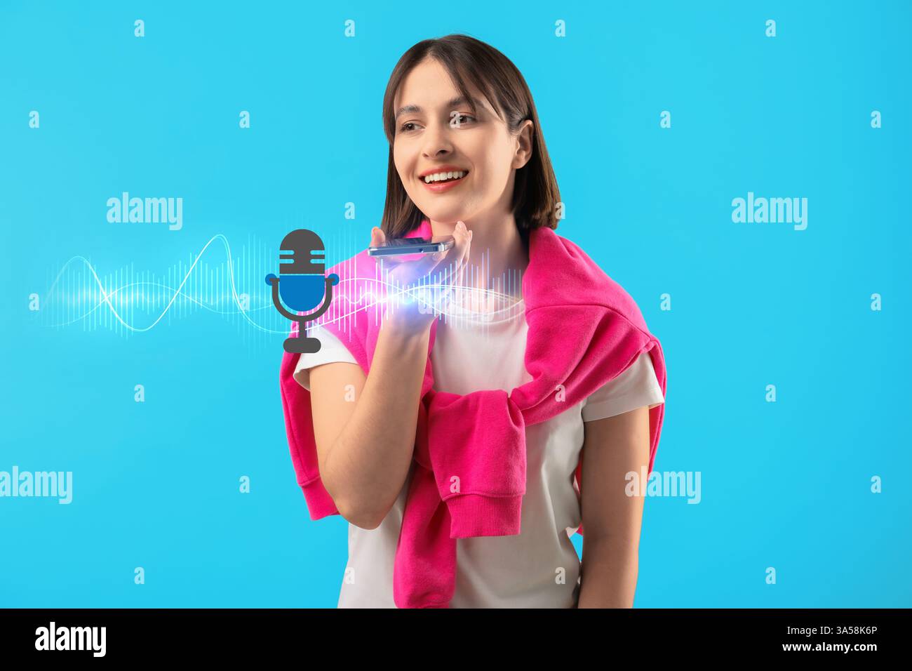 Young woman recording voice message via smartphone on light blue ...