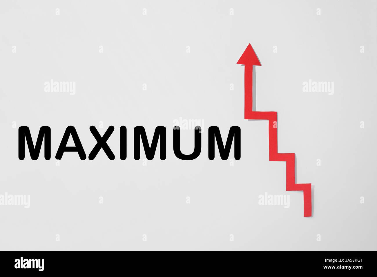 Word Maximum and red arrow on white background, top view Stock Photo ...