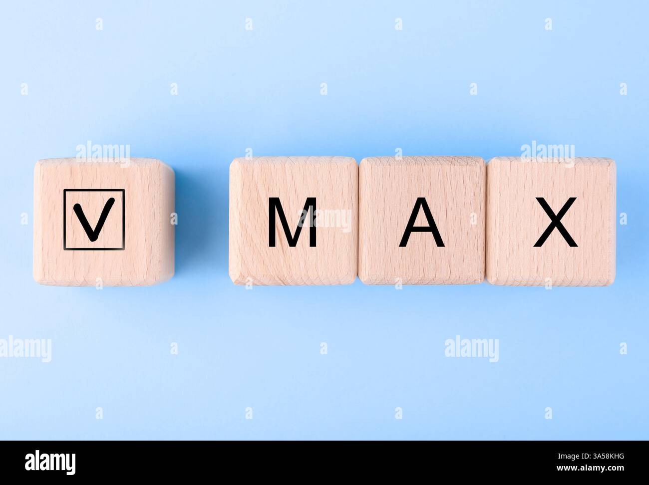Wooden cubes with word Max and checkmark on light blue background, top ...