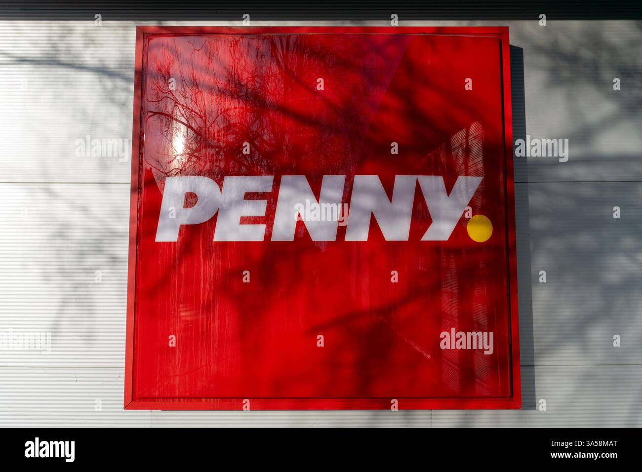 Bright red sign features the name Penny in bold white letters. The sign ...