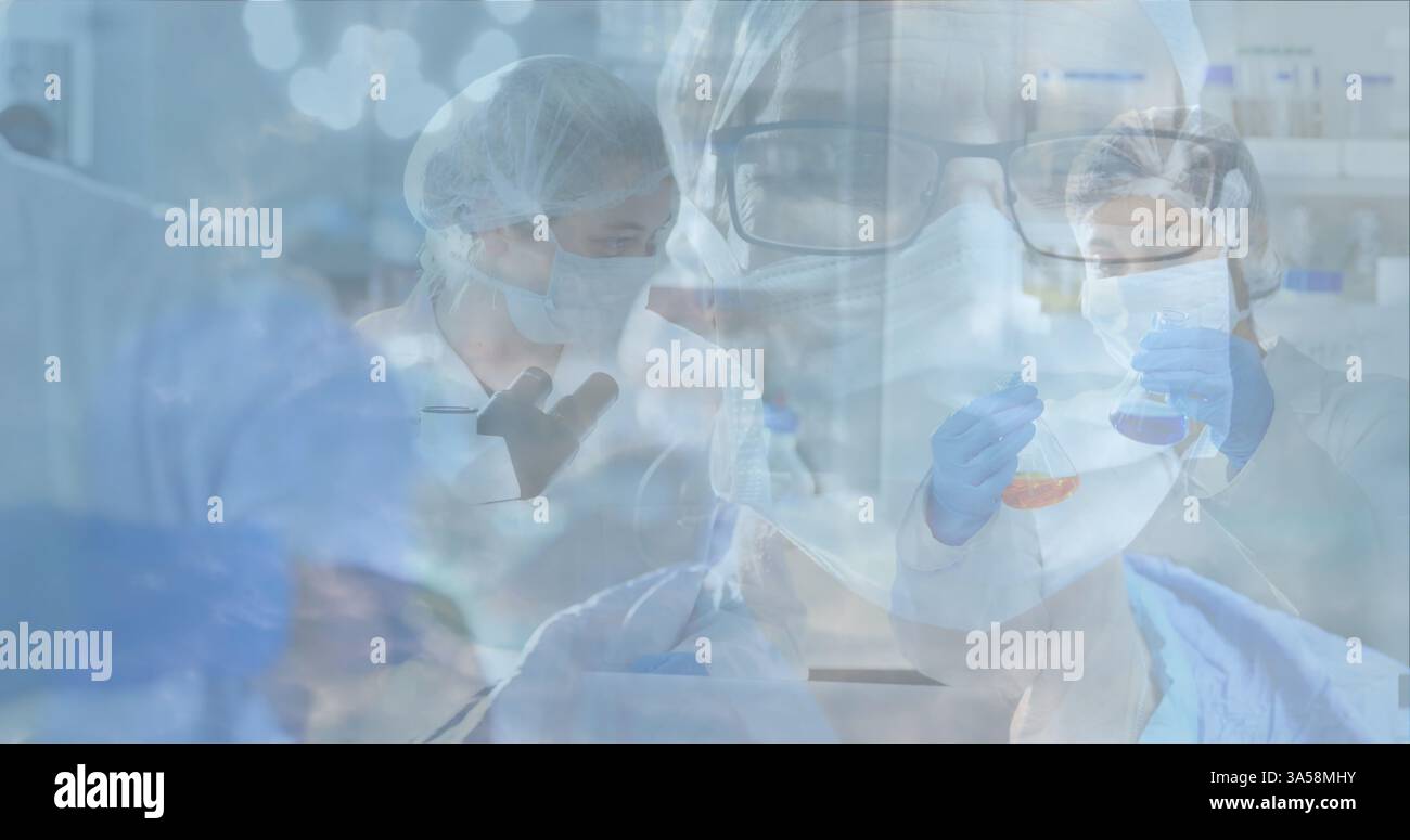Scientists in laboratory wearing protective gear conducting research ...