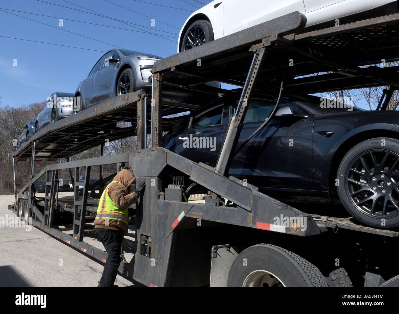 Northbrook, Illinois, USA. 21st Mar, 2025. New Tesla cars are unloaded ...