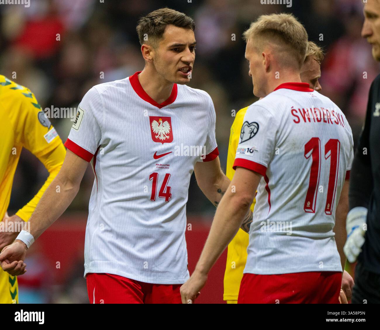 Warsaw, Poland. 21st Mar, 2025. Jakub Kiwior of Poland talks to Karol ...