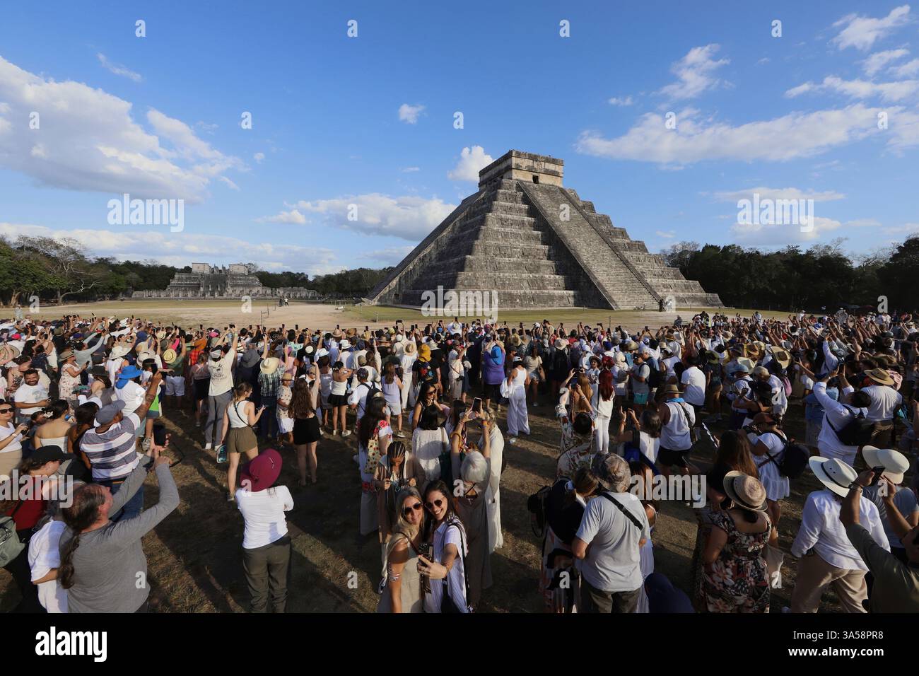People watch the descent of the Kukulkcan serpent as it draws its ...