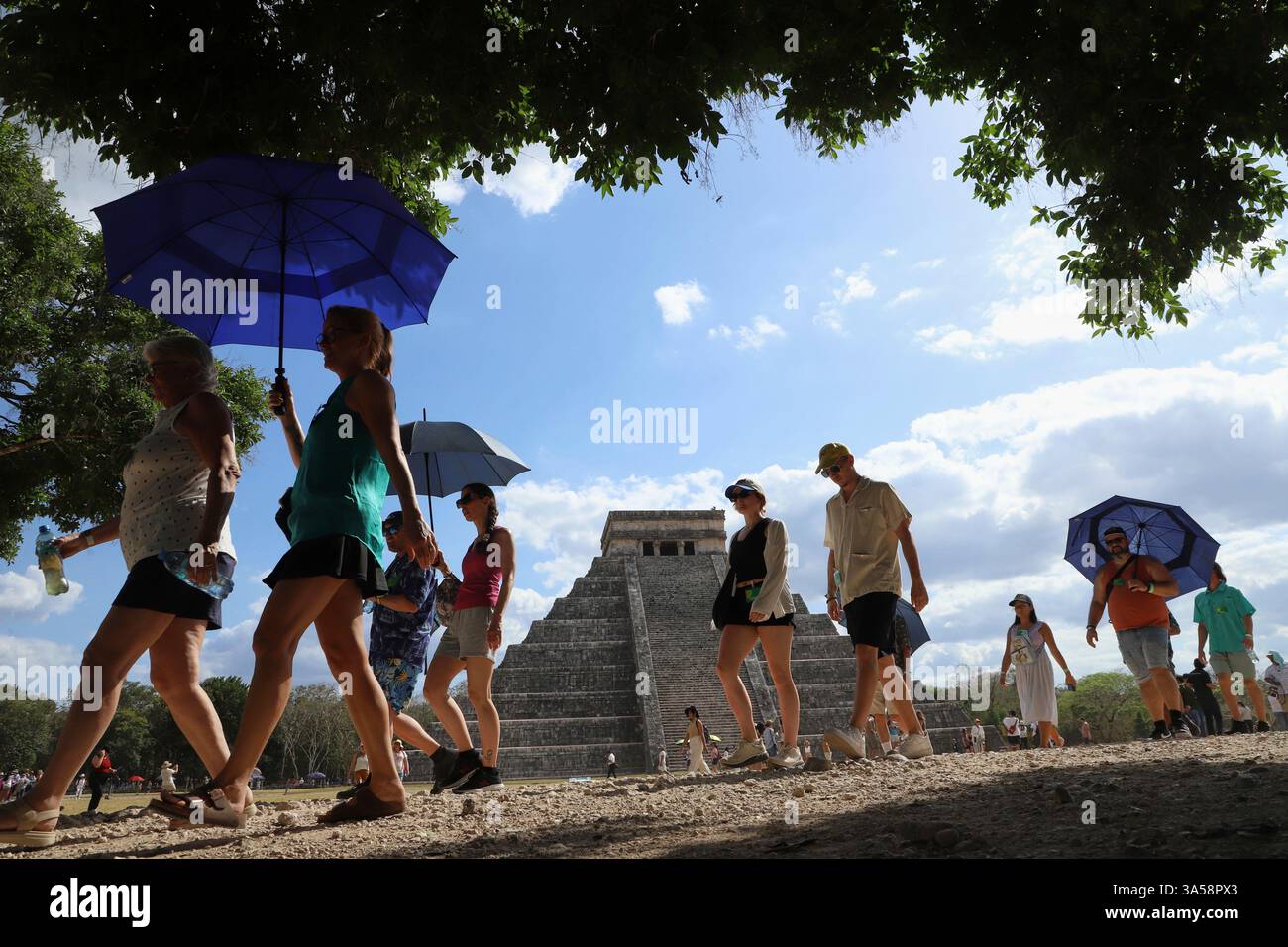 Visitors walk near the Kukulkan Pyramid at the Mayan ruins of Chichen ...